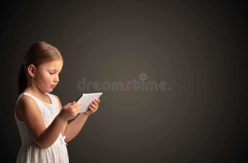 Cute Little Girl Using Tablet with Dark Background Stock Image - Image ...