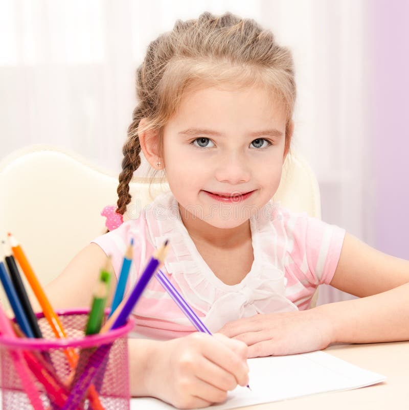 Cute Little Girl is Writing at the Desk Stock Photo - Image of people ...