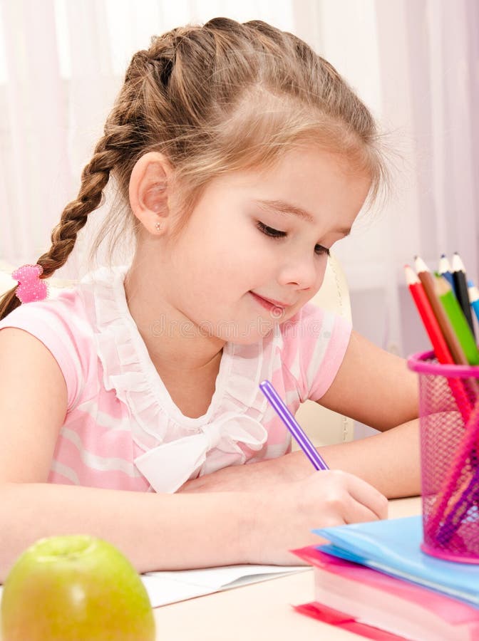 Cute Little Girl is Writing at the Desk Stock Photo - Image of pencils ...