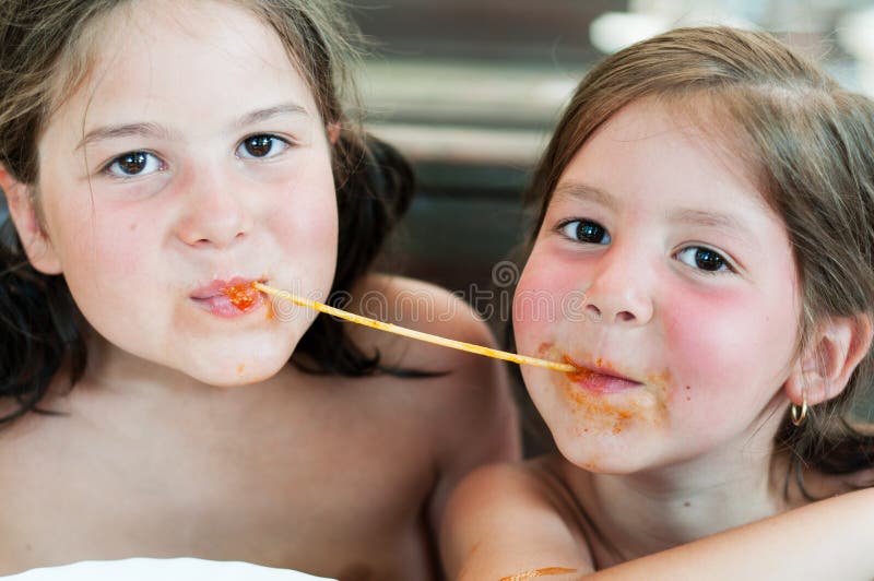 Cute Little Girls Connected with Spaghetti Stock Photo - Image of ...