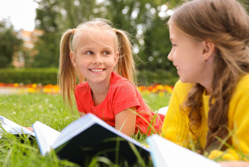 Cute Little Girls Reading Books on Green Grass Stock Photo - Image of ... Cute Little Girls Reading Books on Green Grass Stock Photo - Image of ...