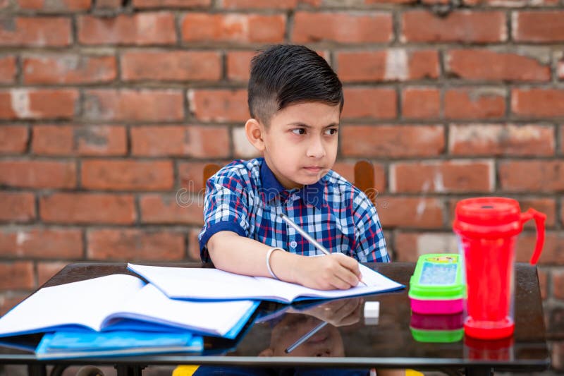 Cute Little Indian/Asian School Kid Studying on Study Table , Writing ...