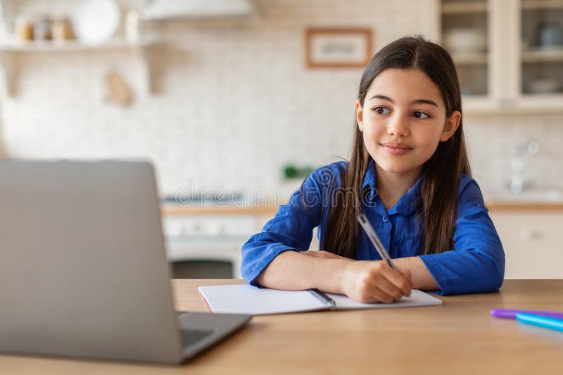 Cute Little School Girl Studying with Laptop and Writing Indoors Stock ...