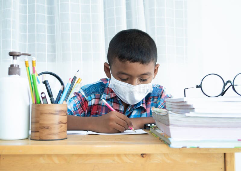 Little Schoolboy Boy Studies at Home Stock Photo - Image of distance ...