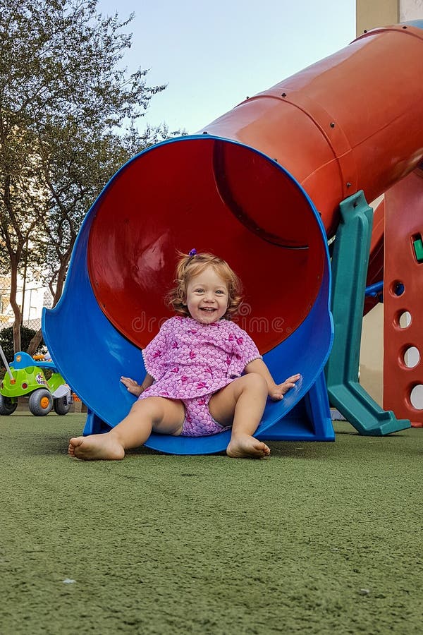 Cute and Joyful Child Smiling on Playground Slide Stock Photo - Image ...
