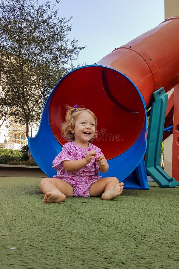 Cute and Joyful Little Child Smiling on Playground Slide Stock Image ...