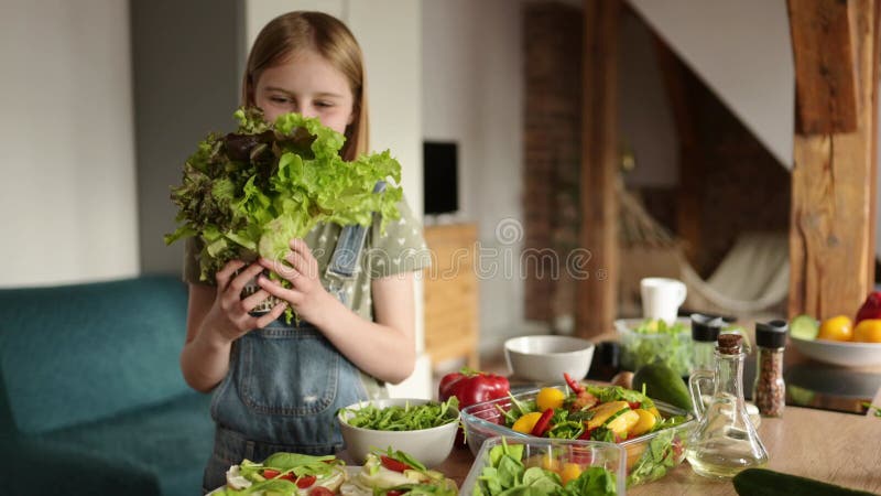 Cute Little Smiling Girl Playing with a Fresh Green Salad Stock Video ... Cute Little Smiling Girl Playing with a Fresh Green Salad Stock Video ...