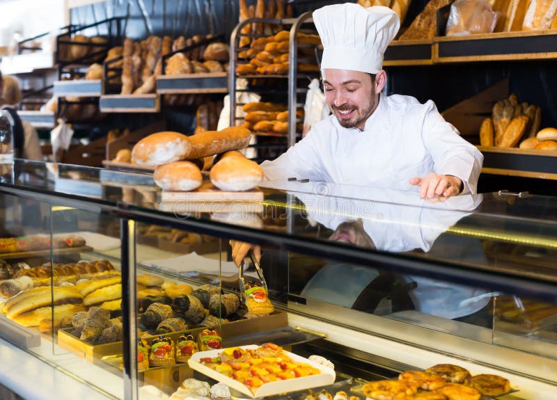 Cute Baker Showing Assortment of Bakery Stock Photo - Image of ...