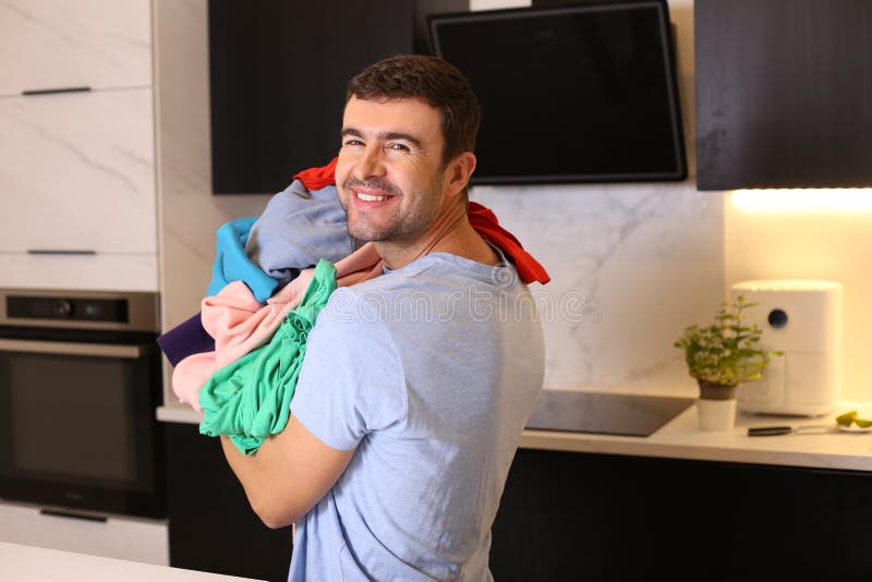 Cute man doing the laundry stock image. Image of gesture - 263512941