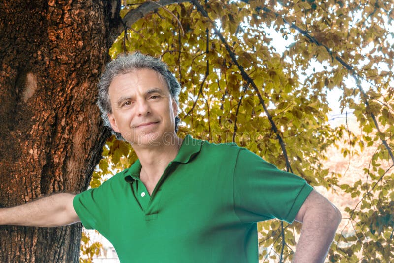 Cute man under a tree stock photo. Image of branches - 62819186