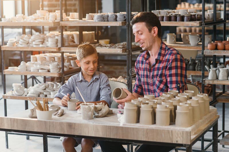 Cute Middle Age Man with His Little Son Having Fun in the Pottery ...