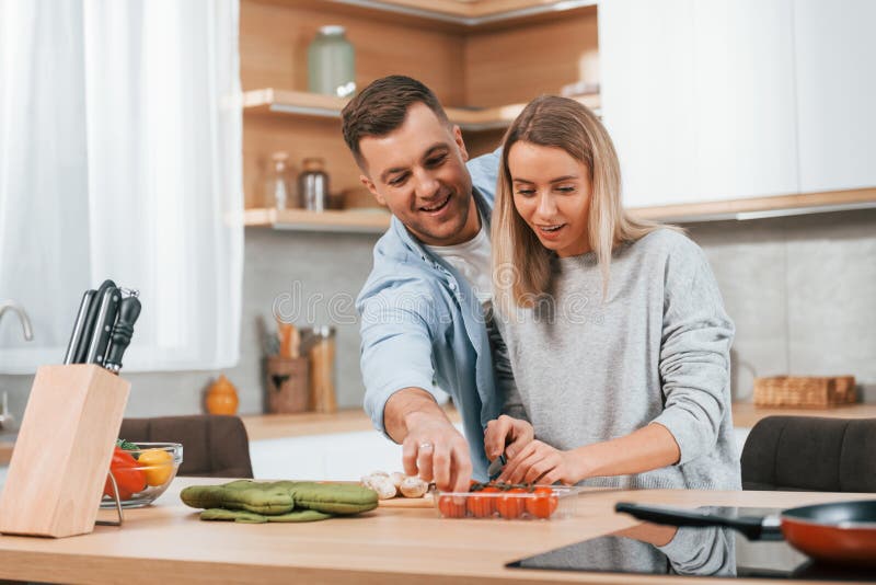 Cute People. Couple Preparing Food at Home on the Modern Kitchen Stock ...