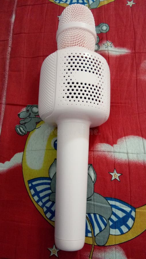 A Cute Pink Bluetooth Microphone on the Bed Stock Image - Image of ...