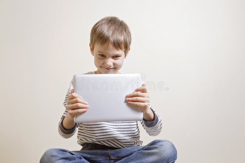 Cute Playful Happy Child with Digital Tablet Computer Playing Games ...