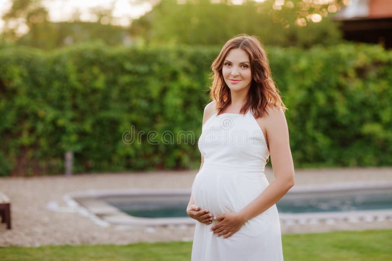 Cute Pregnant Brunette Hugs Pregnant Belly Stock Image Image Of