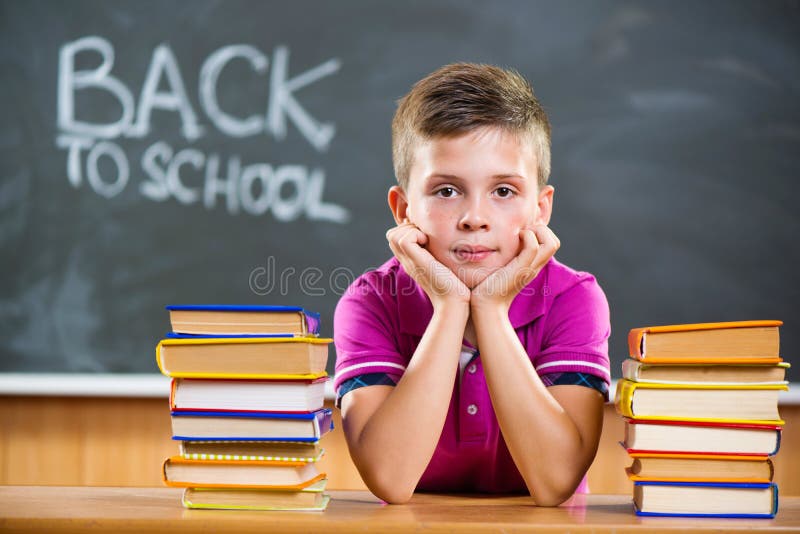 Cute Pupil with Books in Classroom Stock Photo - Image of learning ...