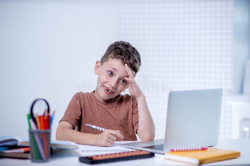 Cute Pupil Boy Studying at Home Writing in Exercise Book Doing Homework ...