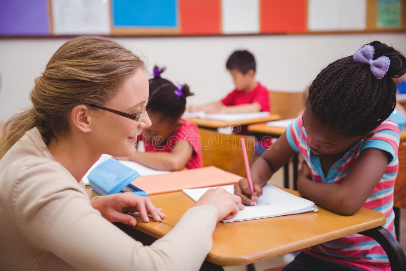 Cute Pupil Getting Help from Teacher in Classroom Stock Photo - Image ...