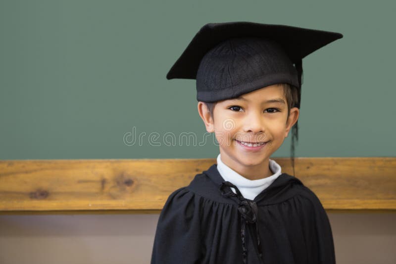 Cute Pupil in Graduation Robe Smiling at Camera in Classroom Stock ...
