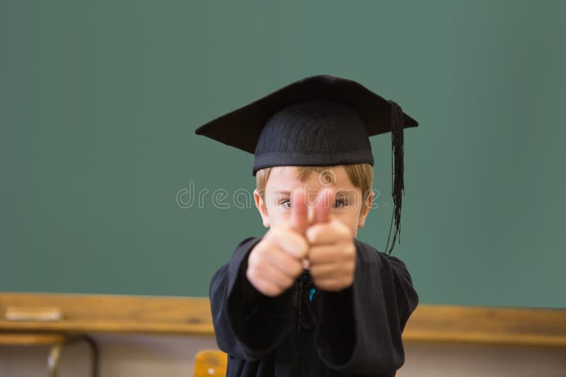 Cute Pupil in Graduation Robe Smiling at Camera in Classroom Stock ...