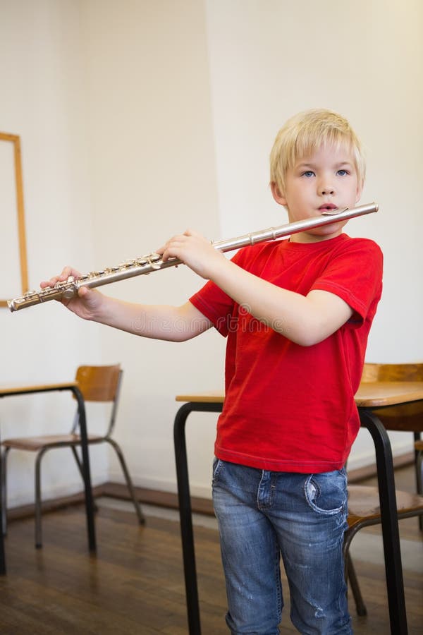 Cute Pupil Playing Flute in Classroom Stock Photo - Image of ...