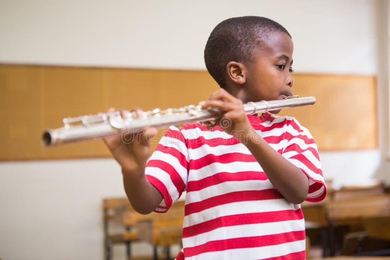 Cute Pupil Playing Flute in Classroom Stock Photo - Image of ...