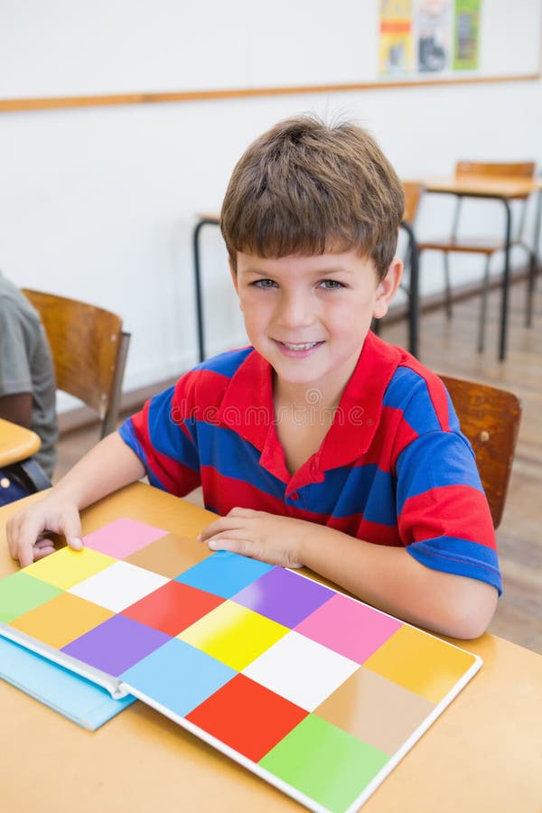 Cute pupil reading at desk stock photo. Image of child - 43660972