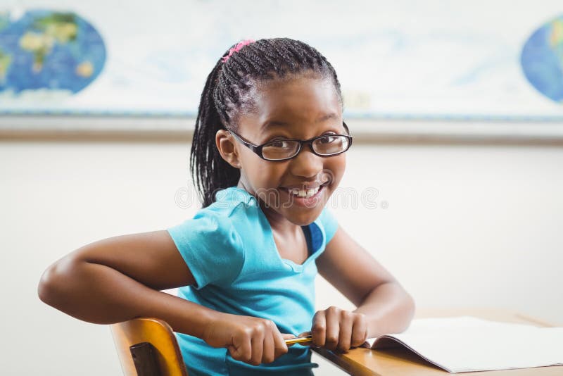 Cute Pupil Sitting at Her Desk in a Classroom Stock Image - Image of ...