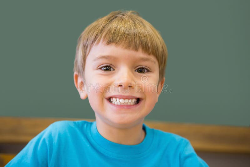 Cute Pupil Smiling at Camera in Classroom Stock Image - Image of ...