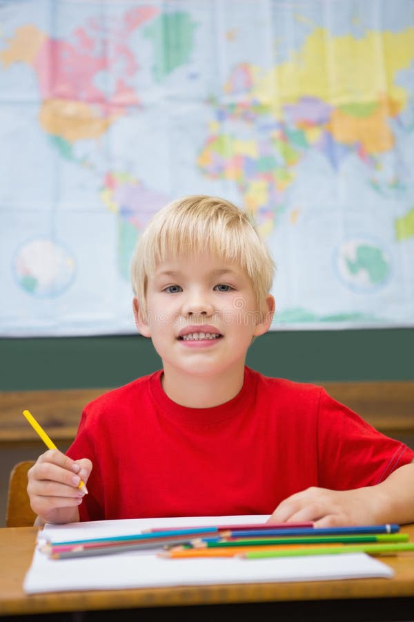 Cute Pupil Smiling at Camera in Classroom at His Desk Stock Photo ...