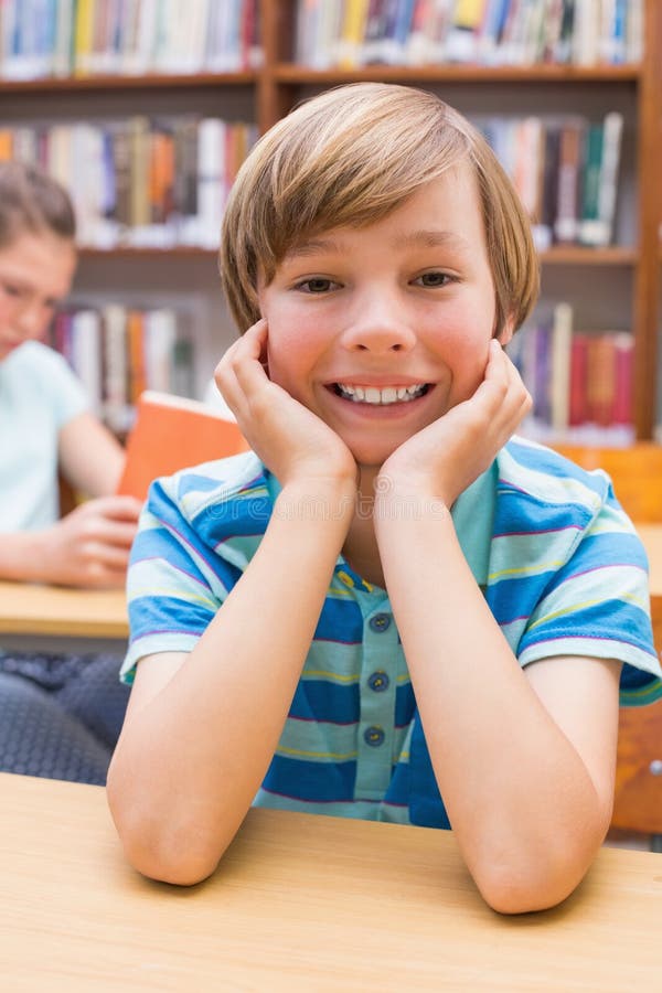 Cute Pupil Smiling at Camera in Library Stock Photo - Image of holding ...
