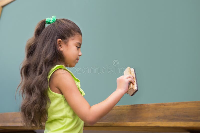 Cute Pupil Standing in Classroom Dusting Chalkboard Stock Photo - Image ...