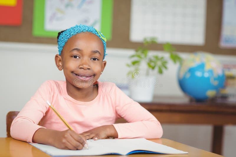 Cute Pupil Working at Her Desk in a Classroom Stock Photo - Image of ...