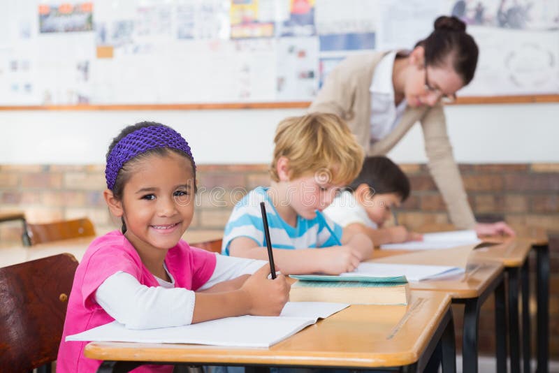 Cute Pupils Drawing at Their Desks One Smiling at Camera Stock Image ...