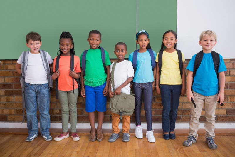 Cute Pupils Smiling at Camera in Classroom Stock Photo - Image of ...