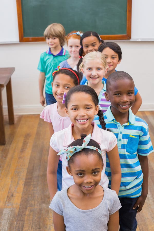 Cute Pupils Smiling at Camera in Classroom Stock Image - Image of child ...