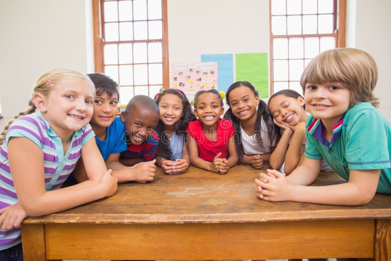 Cute Pupils Smiling at Camera in Classroom Stock Image - Image of desk ...