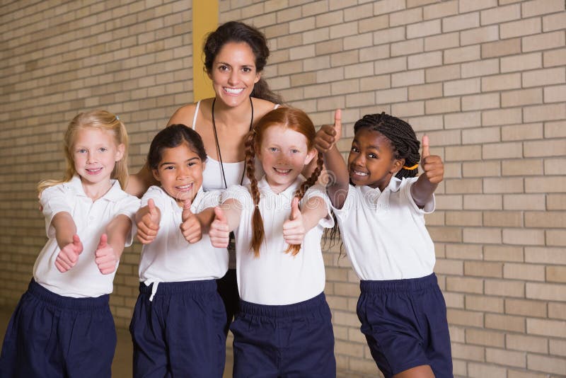 Cute Pupils Smiling at Camera in PE Uniform Stock Photo - Image of ...