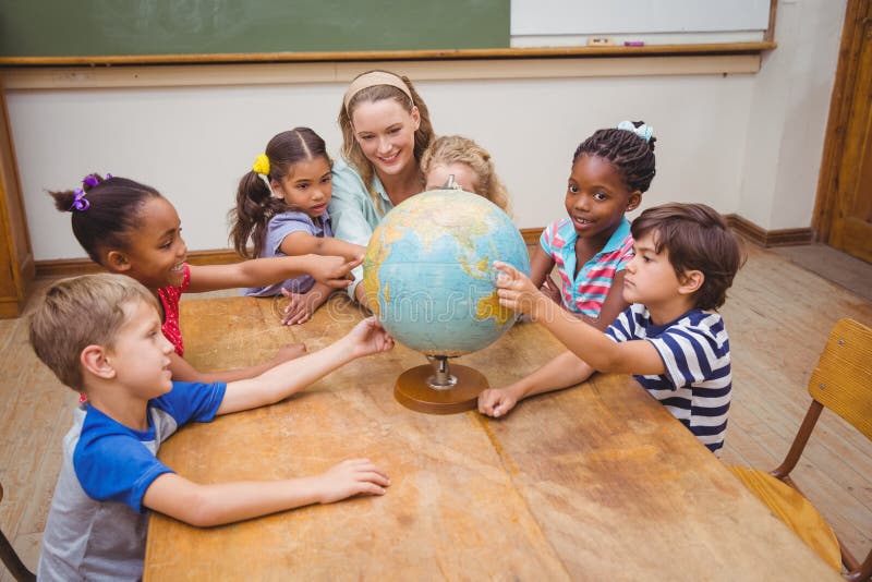 Cute Pupils and Teacher in Classroom with Globe Stock Photo - Image of ...