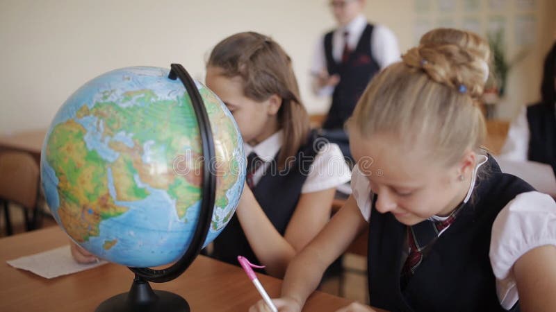 Cute Pupils and Teacher in Classroom with Globe at the Elementary ...