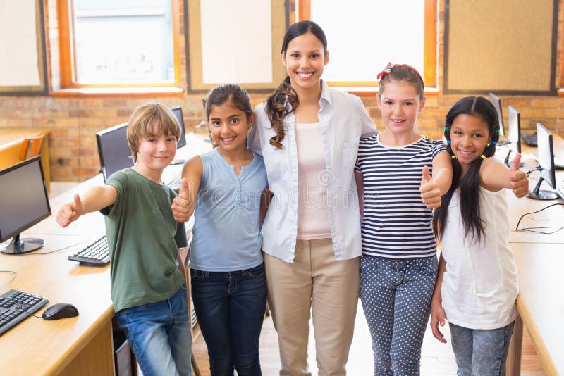 Cute Pupils and Teacher Smiling at Camera in Computer Class Stock Photo ...