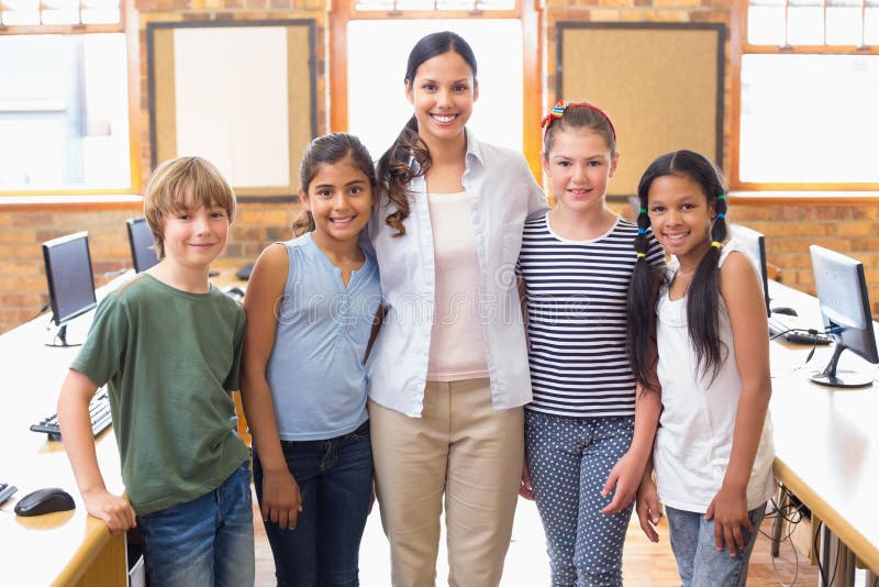 Cute Pupils and Teacher Smiling at Camera in Computer Class Stock Photo ...