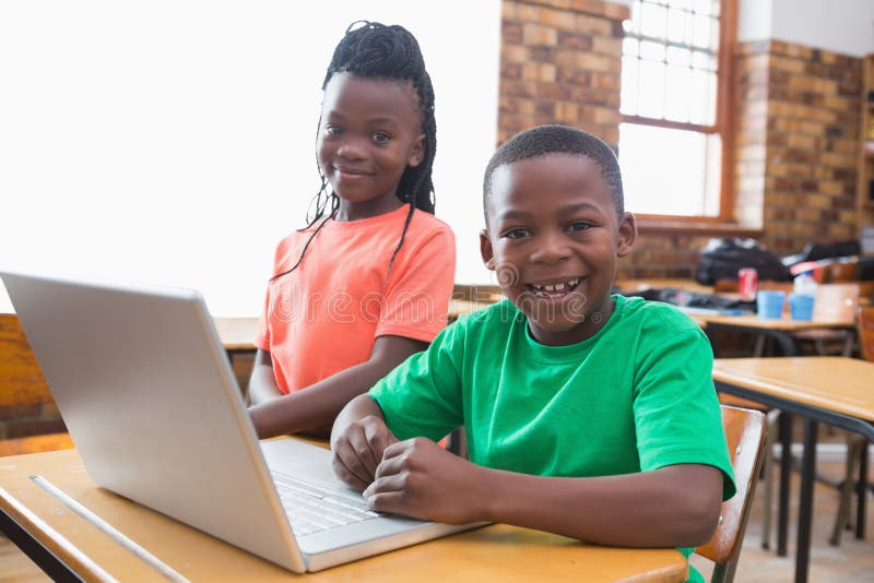 Cute Pupils Using Laptop in Classroom Stock Photo - Image of knowledge ...