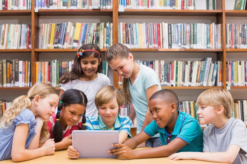 Cute Pupils Using Tablet Computer in Library Stock Photo - Image of ...