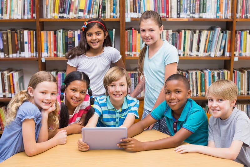 Cute Pupils Using Tablet Computer in Library Stock Image - Image of ...