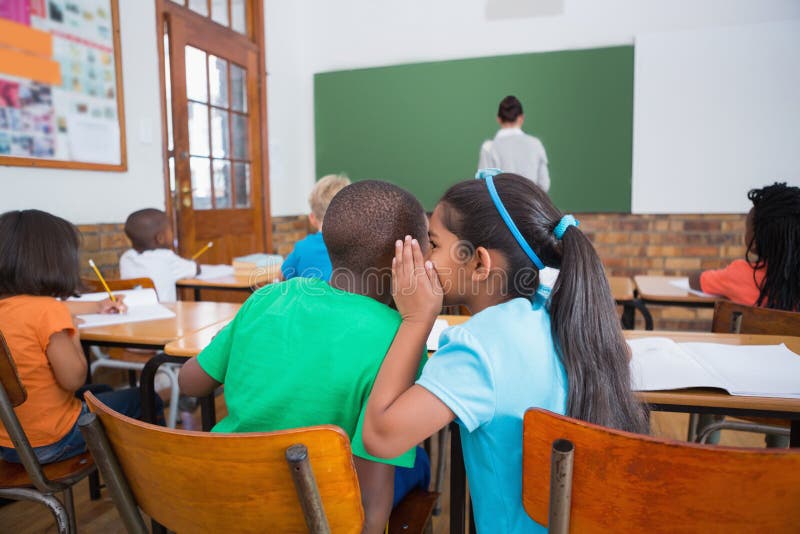 Cute Pupils Whispering in Classroom Stock Photo - Image of learn, girl ...
