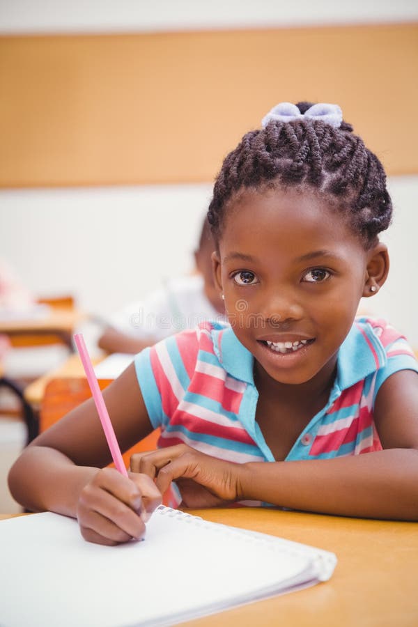 Cute Pupils Writing at Desk in Classroom Stock Image - Image of cute ...