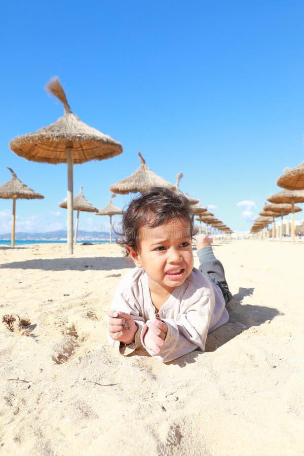Sad Boy Lying on Beach on Mallorca Stock Photo - Image of beach, shadow ...