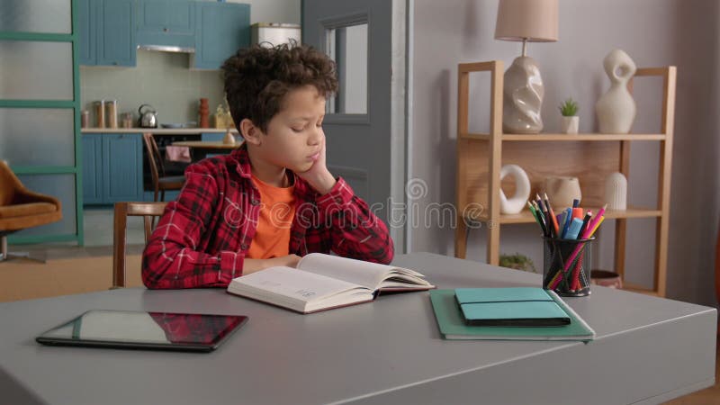 Bored School Age Black Boy Having Problems with Educational Material at ...