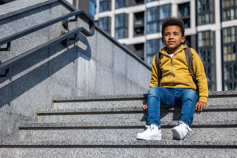Cute Schoolboy Sitting on the Steps and Resting Stock Photo - Image of ...